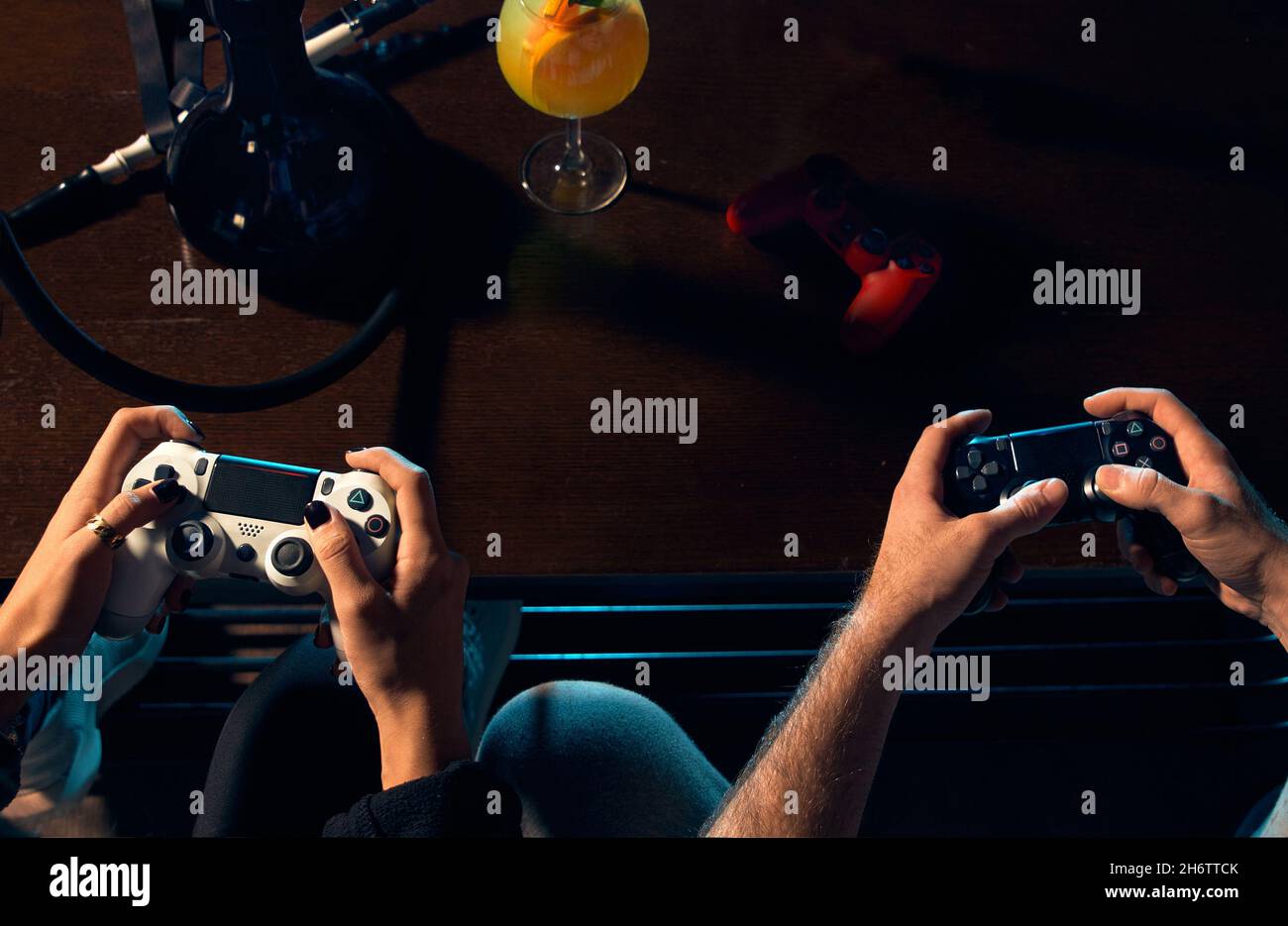 friends playing console video games. controller in hands closeup. neon ...