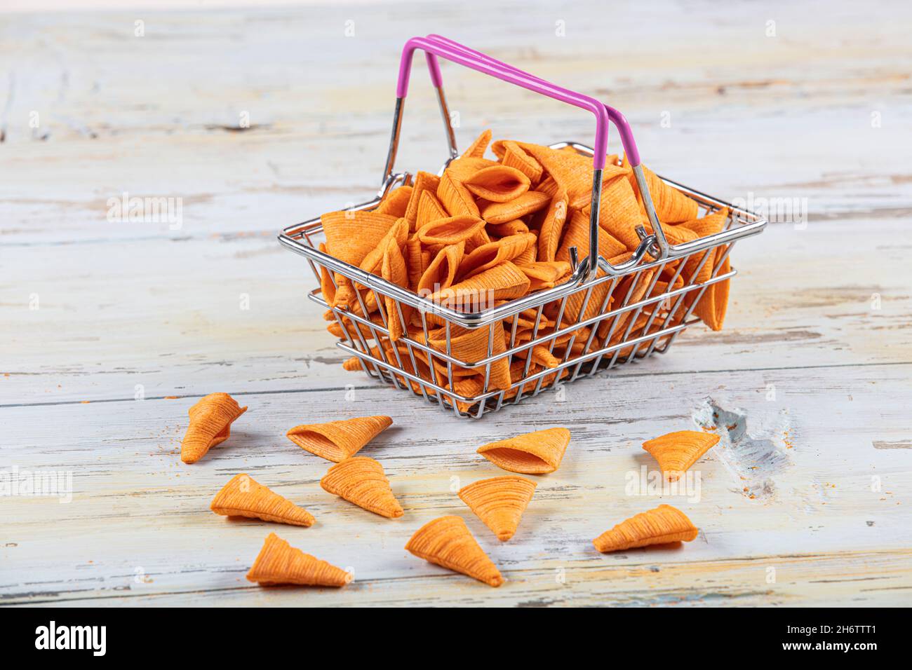 Portion of cone shaped snack tornado shaped crackers. Yellow spicy ...