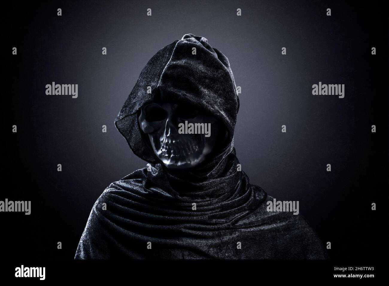 Grim reaper over dark misty background Stock Photo - Alamy