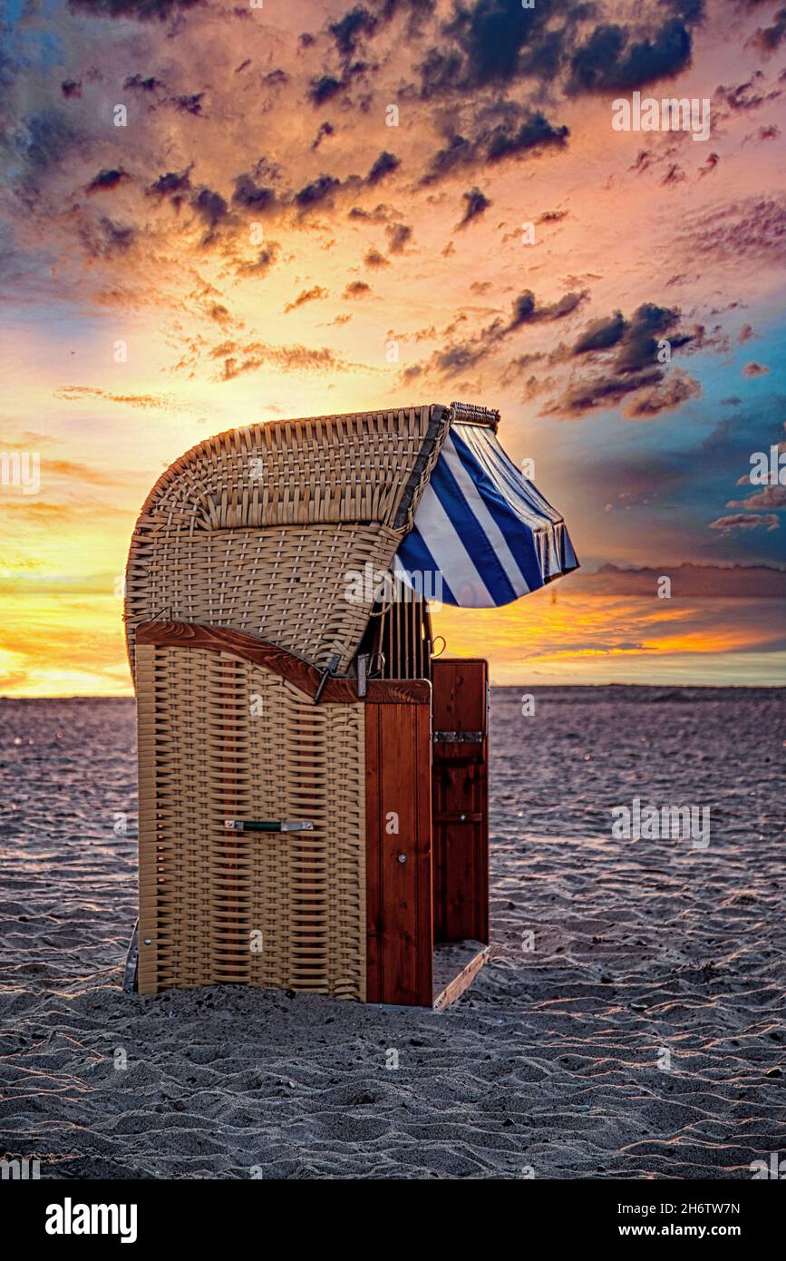 Vertical shot of a wooden bench with cover on the beach with background ...