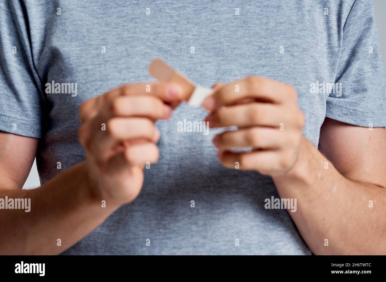 man holding plaster in hands treatment help Stock Photo - Alamy
