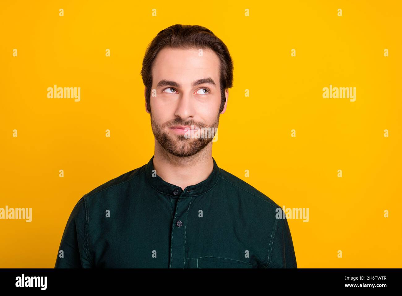 Photo of cool young guy look empty space wear green shirt isolated on ...