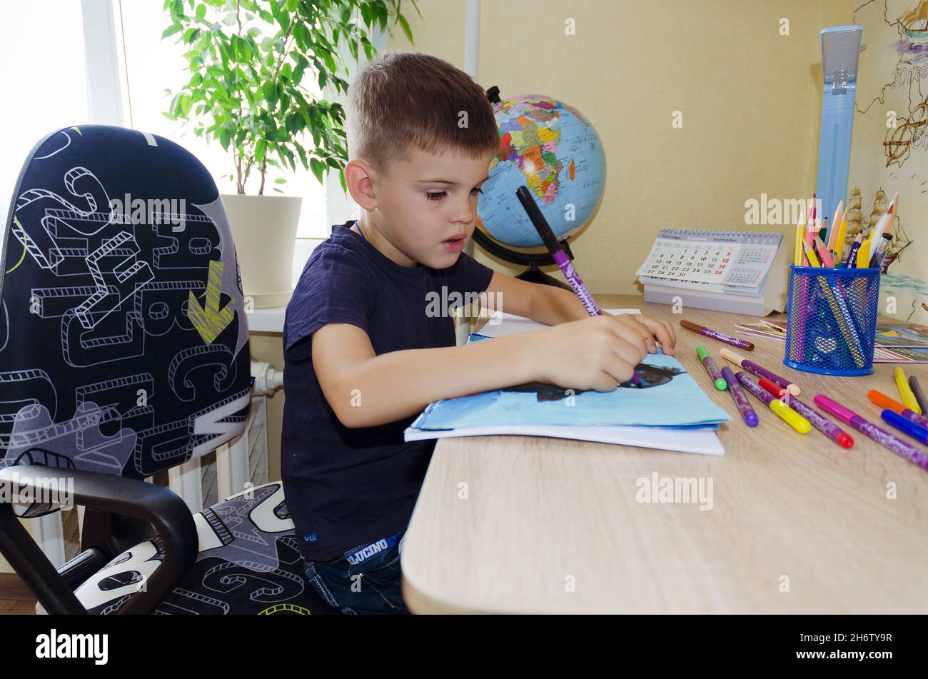 Back to school. Little tired boy doing homework at home with backpack ...