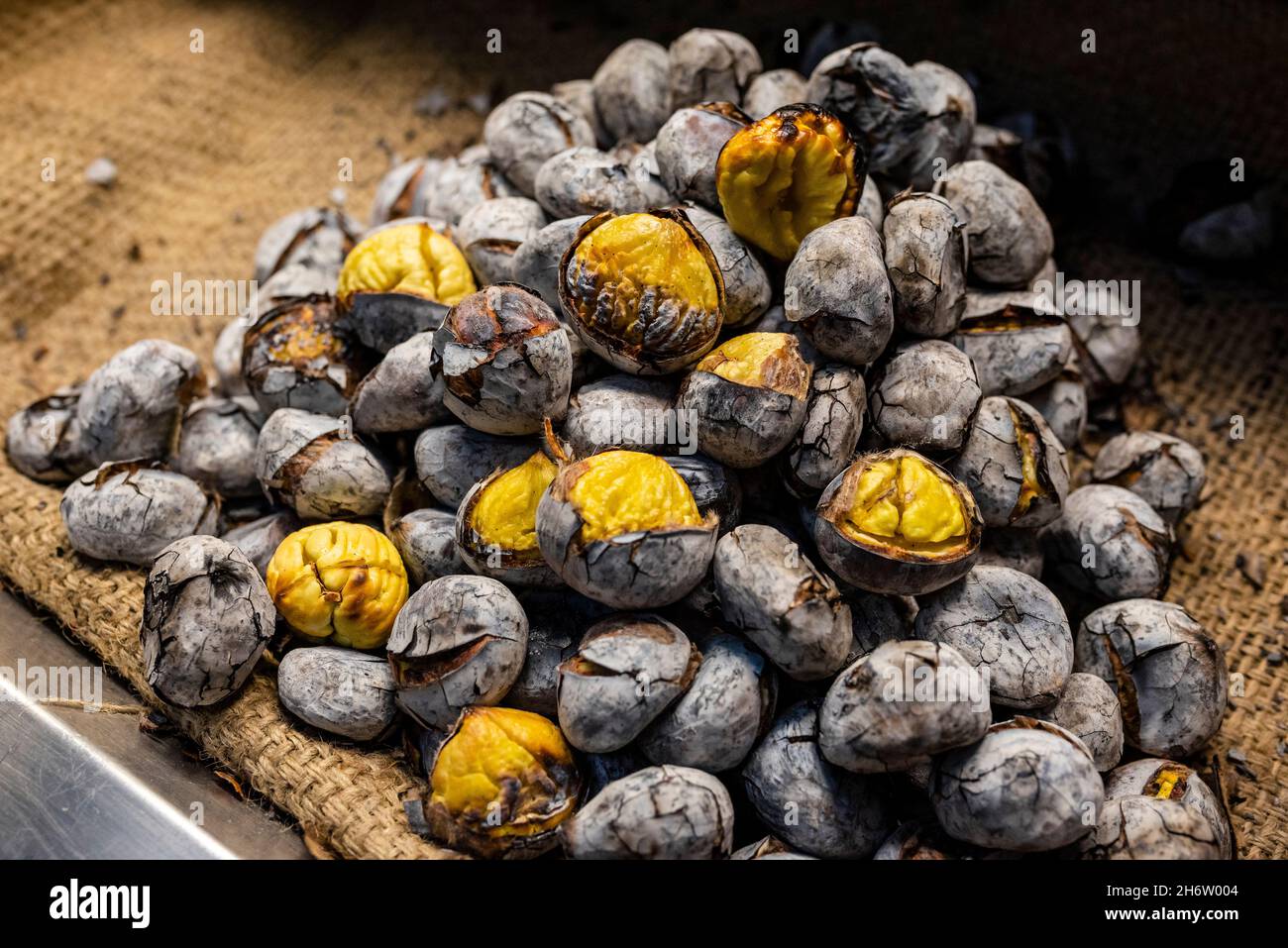 Heap of delicious chestnuts roasted on fire in Faro, Portugal Stock ...