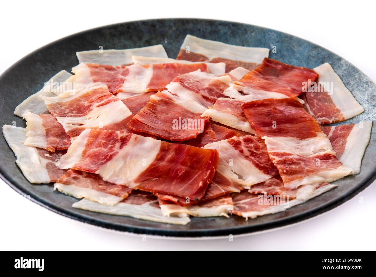 Spanish serrano ham isolated on white background Stock Photo - Alamy