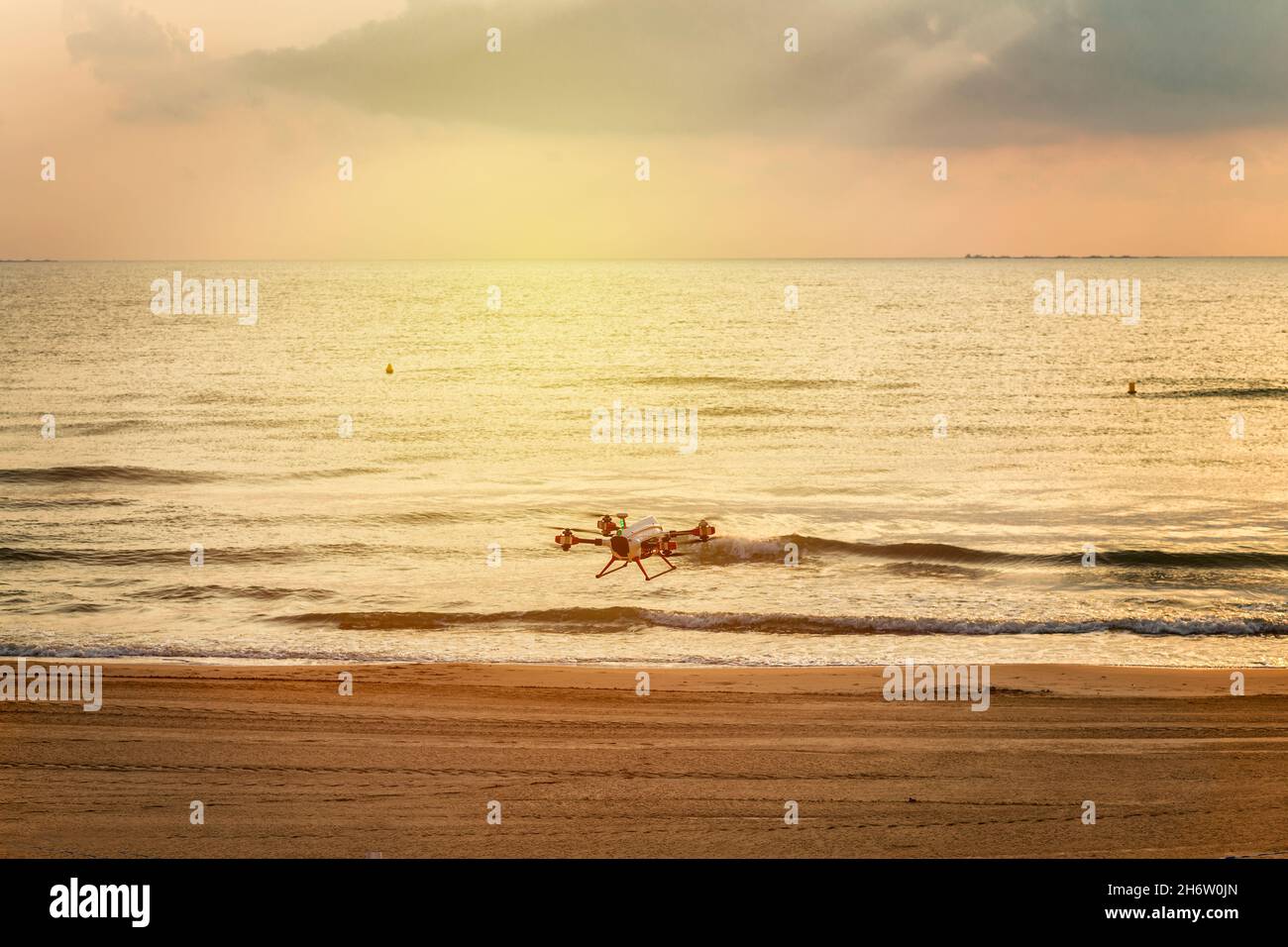 Drone flying above beach Stock Photo - Alamy