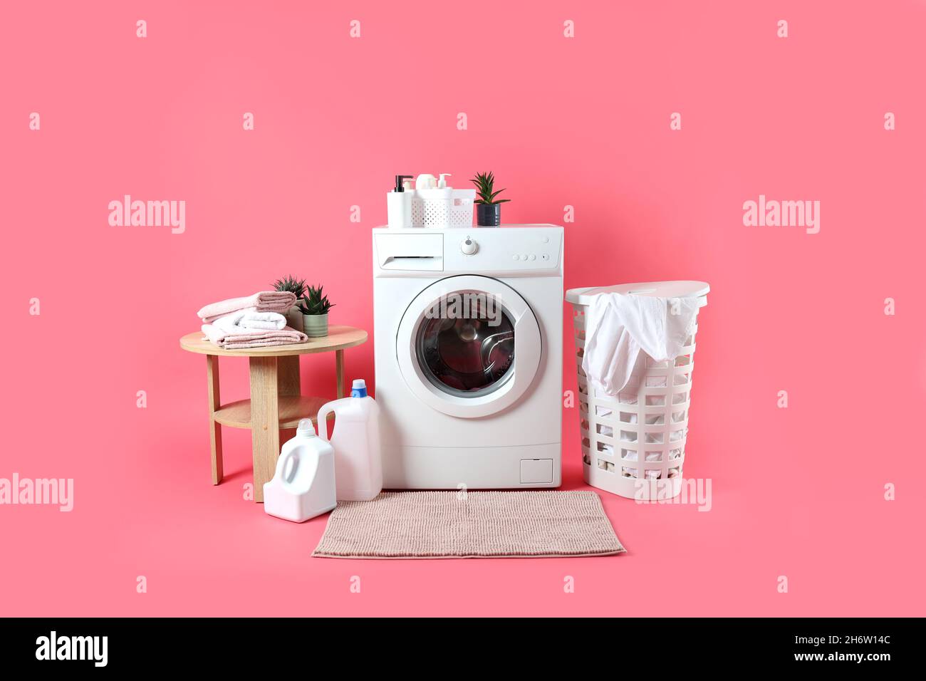 Concept of housework with washing machine on pink background Stock ...