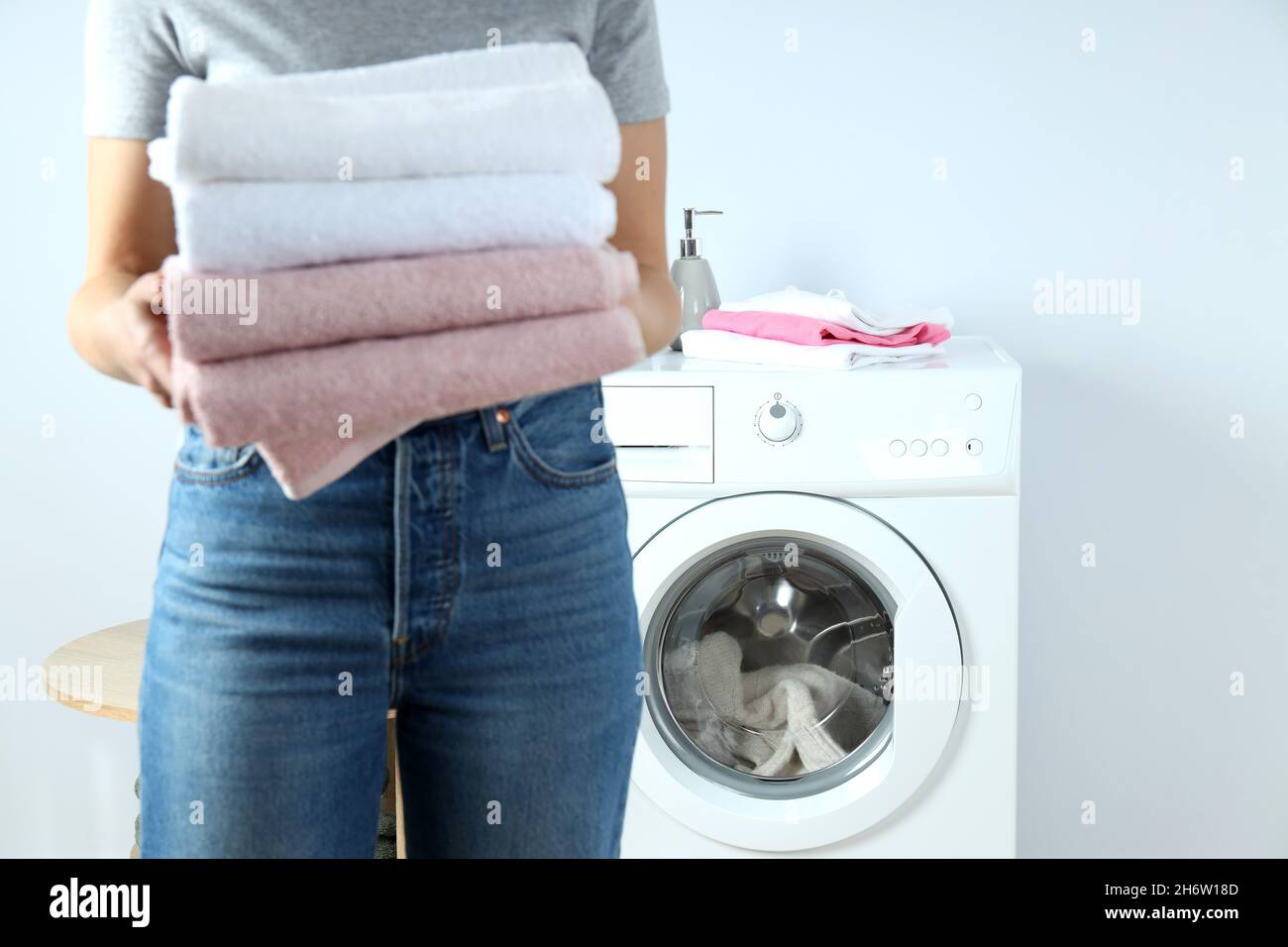 Concept of housework with washing machine and girl on white background ...