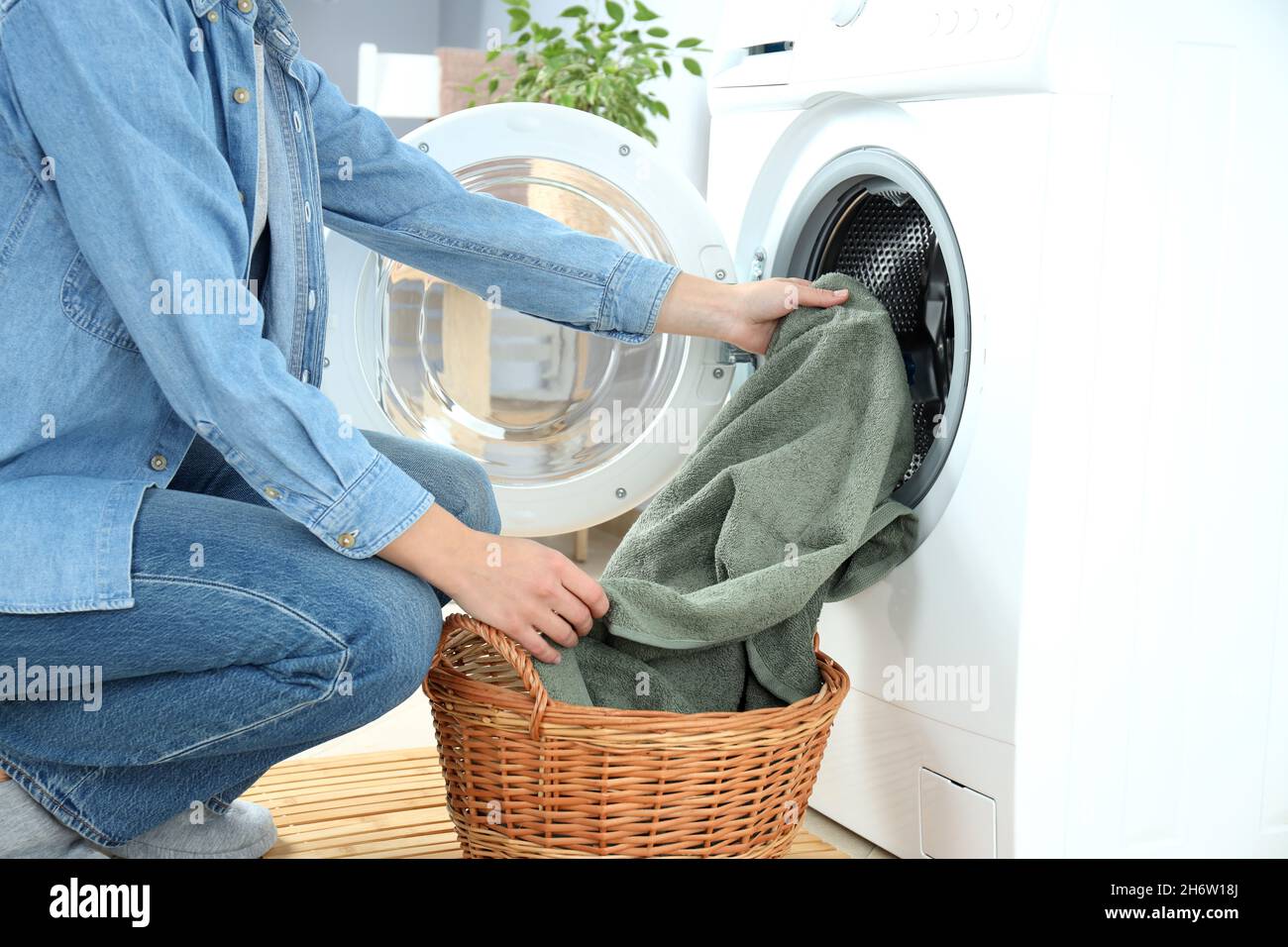 Concept of housework with washing machine and girl on white background ...