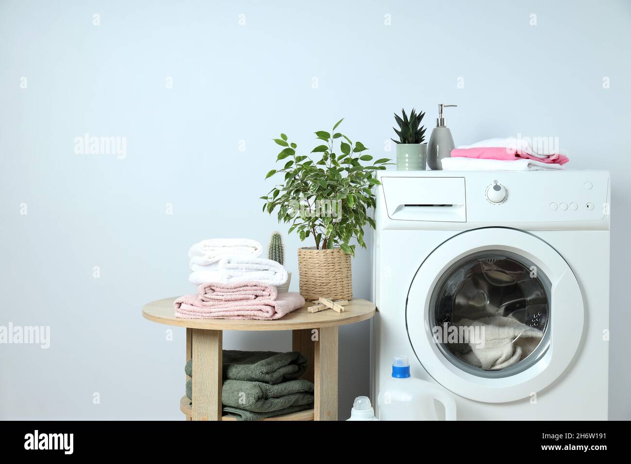 Concept of housework with washing machine on white background Stock ...