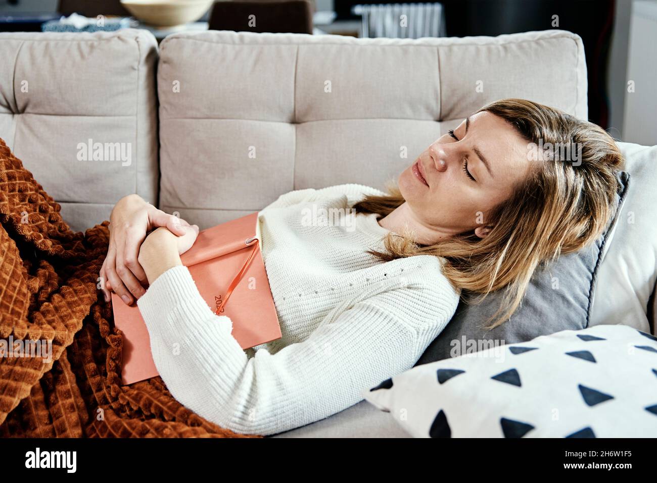 Woman fell asleep while reading a book on the couch. Leisure day ...