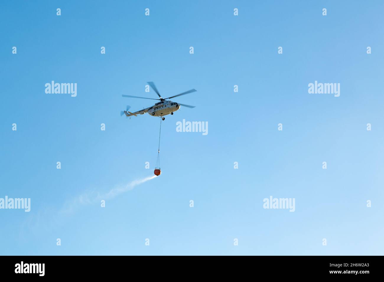 Wildfire helicopter going to fire area to extinguish forest fire ...