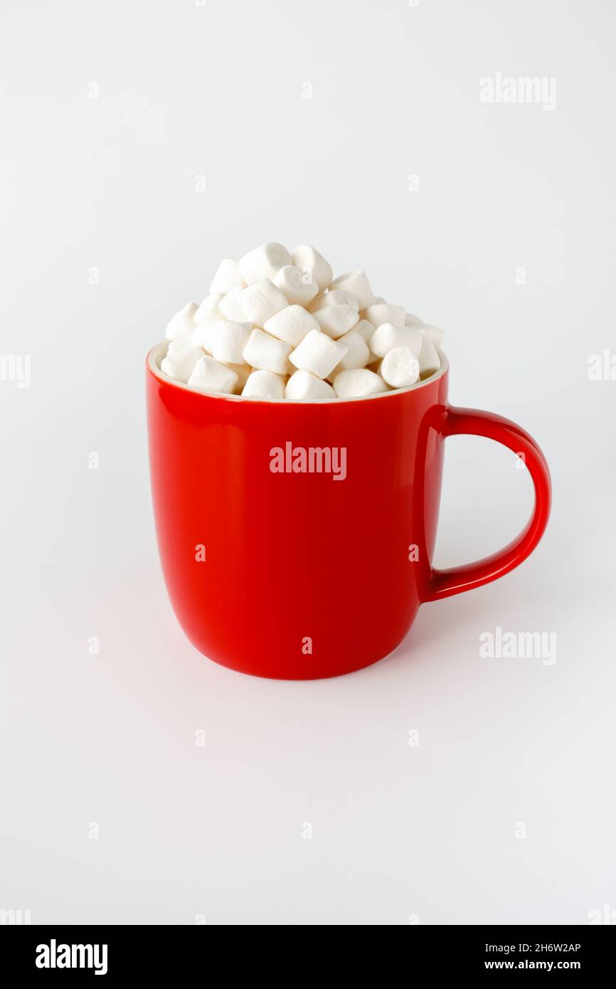 Red mug filled with mini marshmallows isolated on white. Low angle view ...