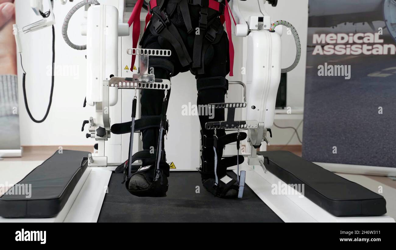 close-up of a child patient rehabilitating on a machine in a ...
