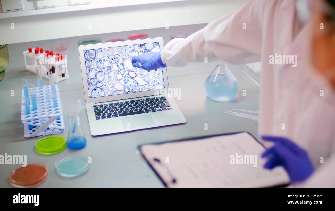 close-up of a computer screen with molecules on a laboratory bench next ...