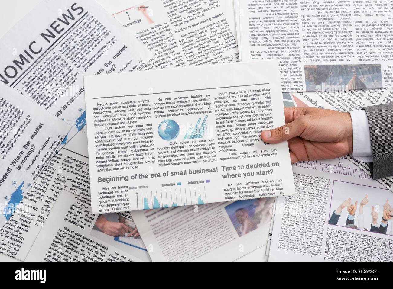 top view of businessman holding newspaper Stock Photo - Alamy