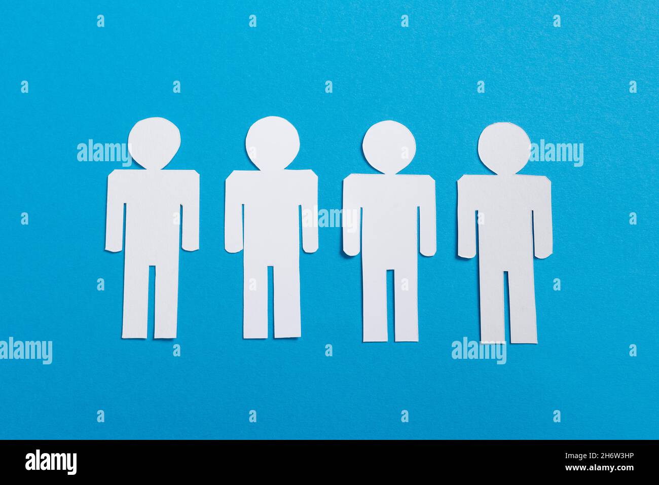 top view of white paper cut people isolated on blue, team concept Stock ...