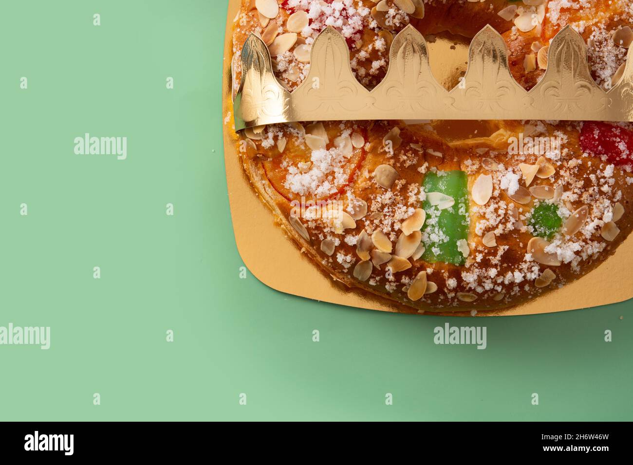 Spanish typical epiphany cake "Roscon de Reyes" on green background ...