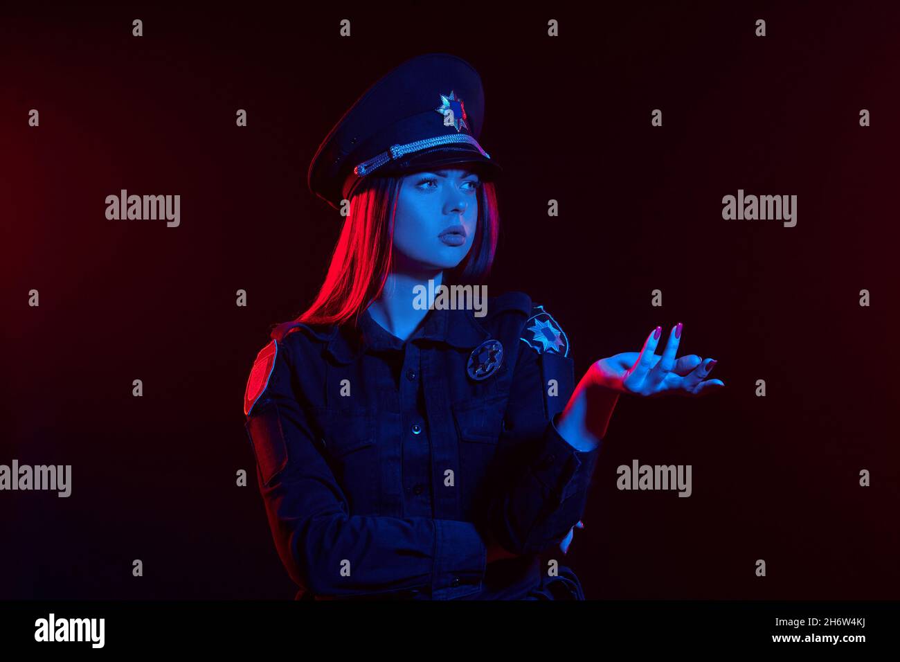 Close-up shot of a redheaded female police officer is posing for the ...