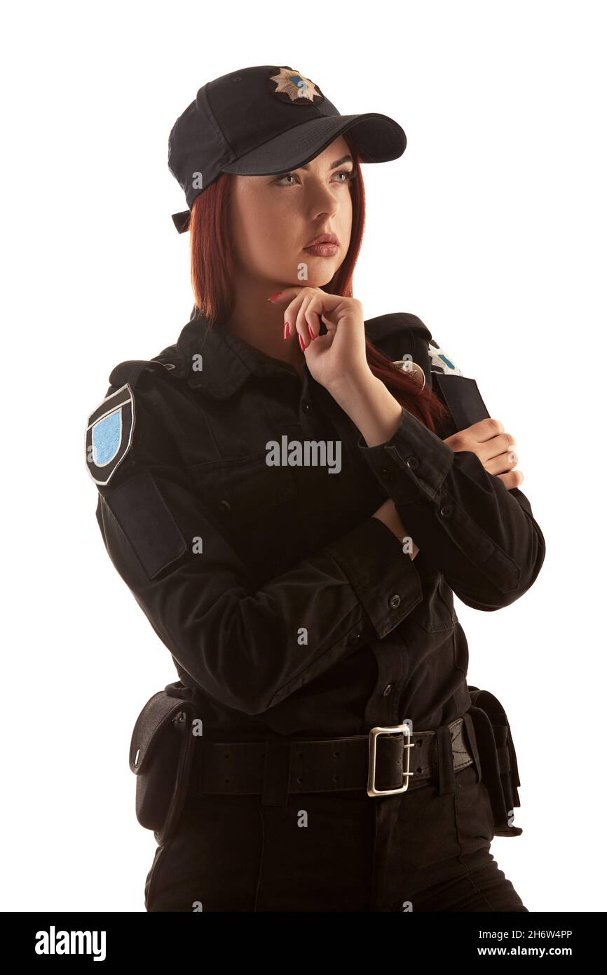 Redheaded female police officer is posing for the camera isolated on ...