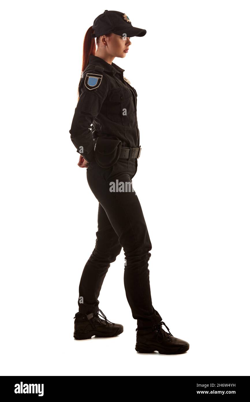 Full length shot of a redheaded female police officer posing for the ...