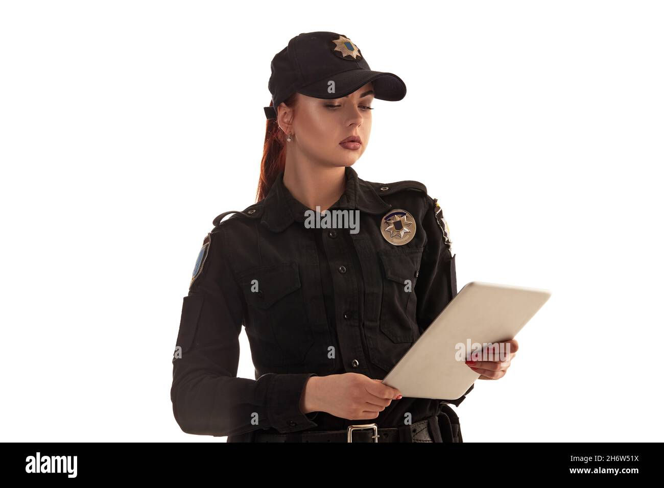 Close-up shot of a redheaded female police officer posing for the ...