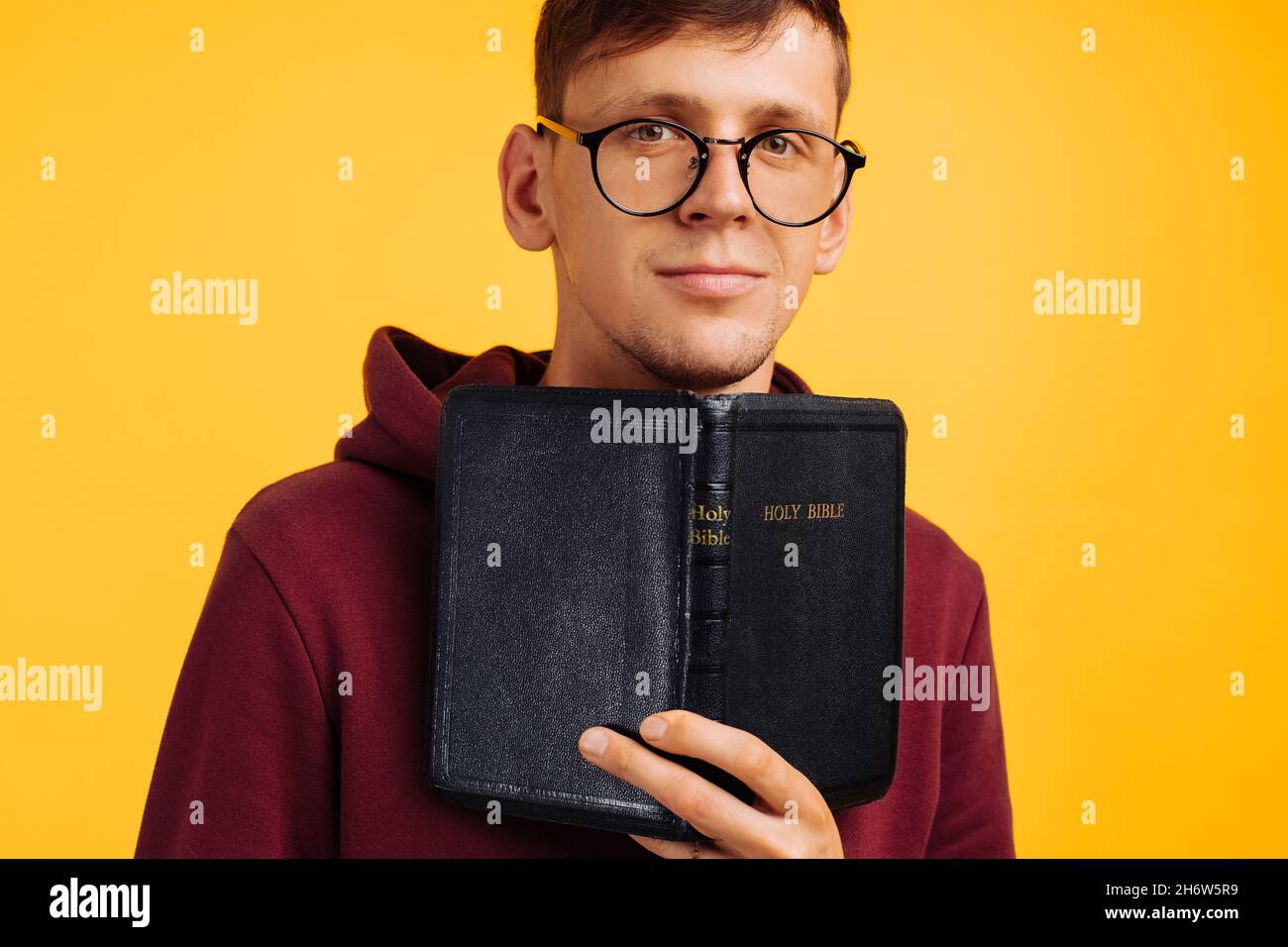 Christian man is reading and studying the Bible, the man is holding the ...