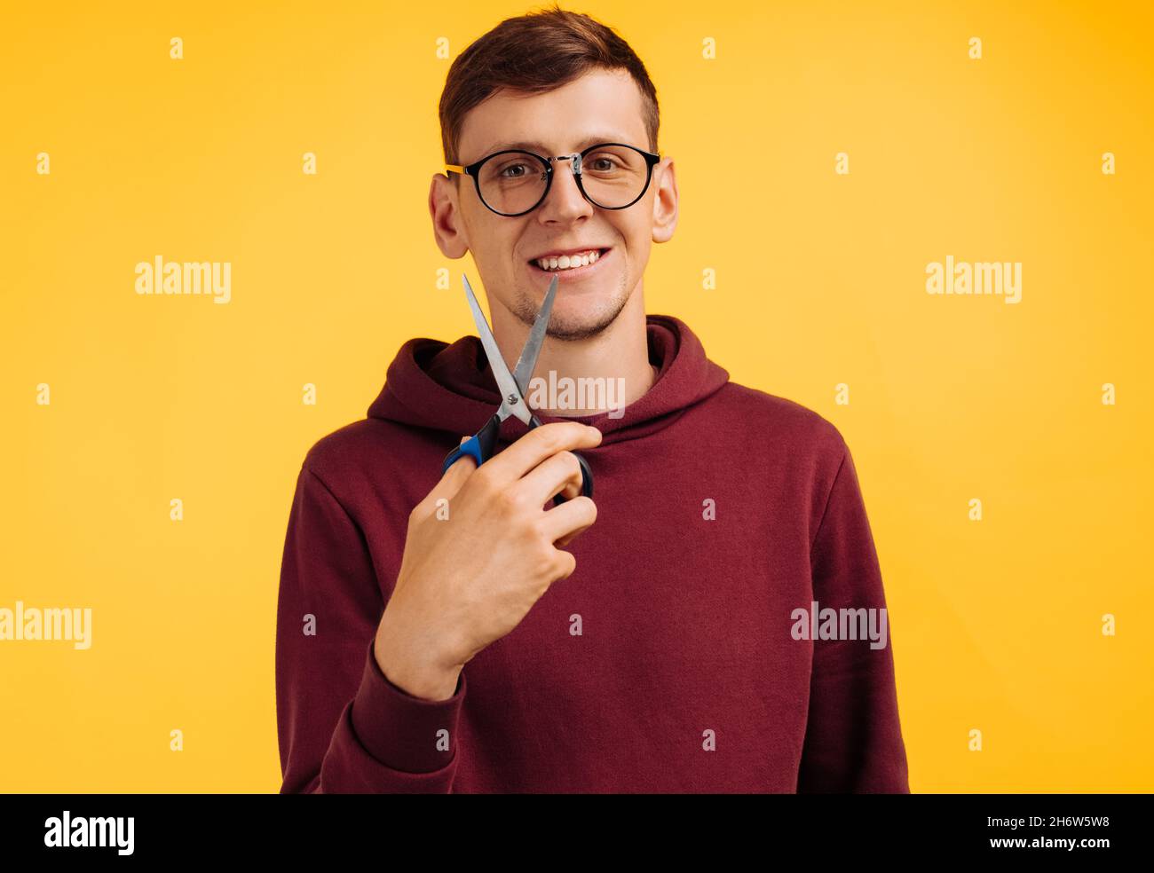 Portrait of male dressmaker holding sewing pattern, sketch and design ...