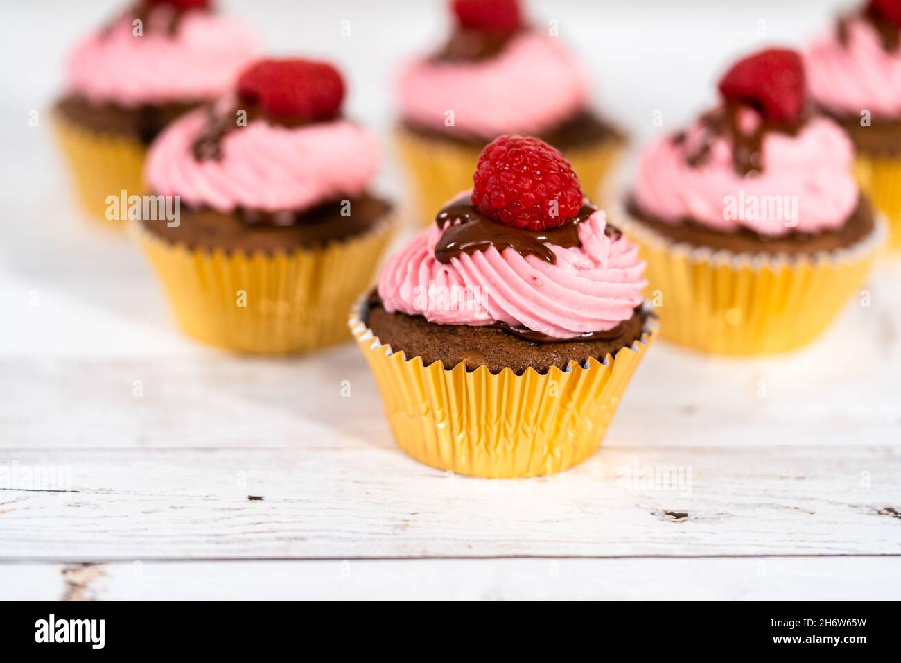 Gourmet chocolate raspberry cupcakes drizzled with chocolate ganache ...