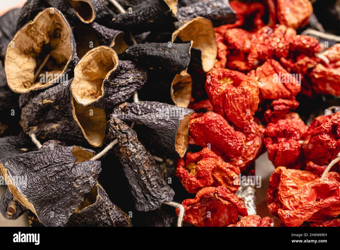 Dry eggplant and dry bell chili hanging in the market, local ingredient ...