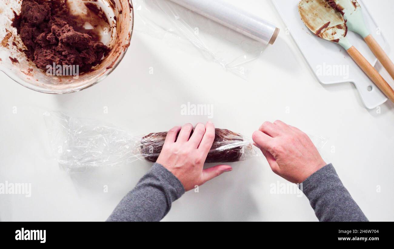 Step by step. Flat lay. Wrapping cookie dough into the plastic wrap to ...