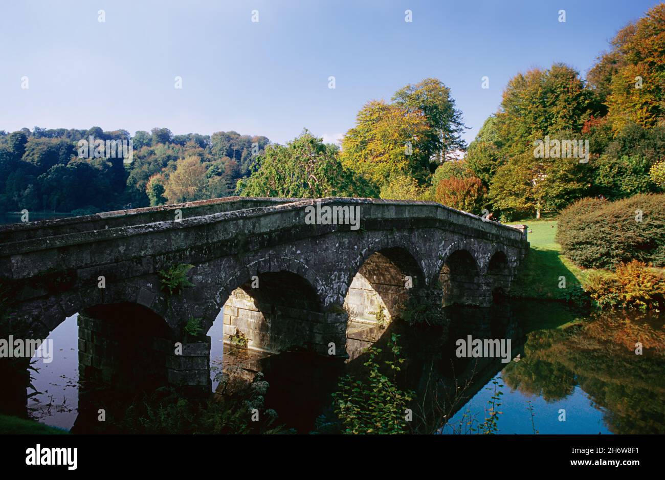 The C18th Palladian bridge in Stourhead Garden, Wiltshire, England, UK ...