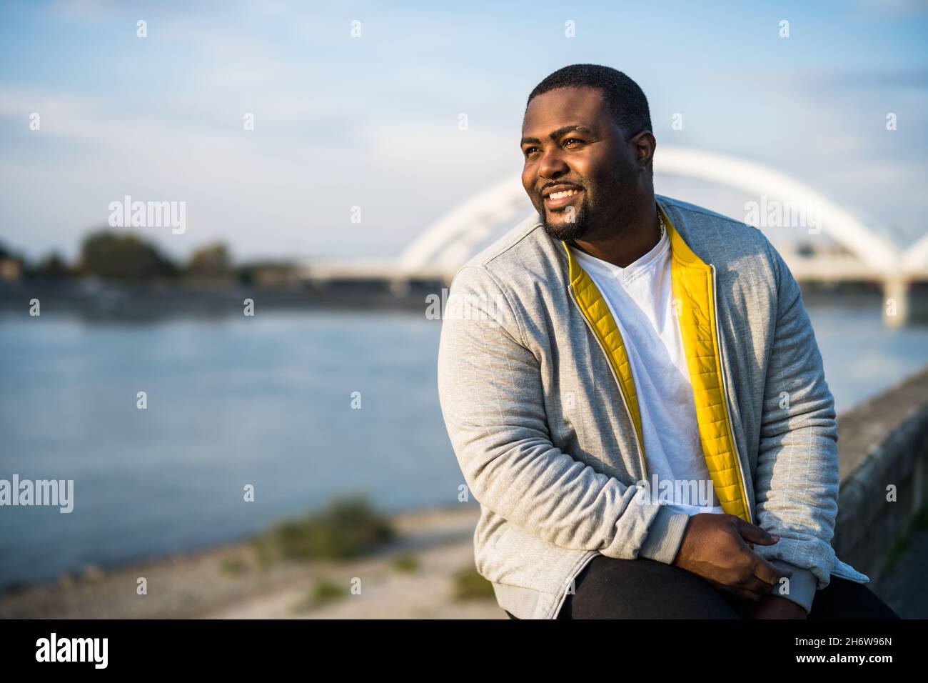 Happy black man enjoys resting by the river Stock Photo - Alamy