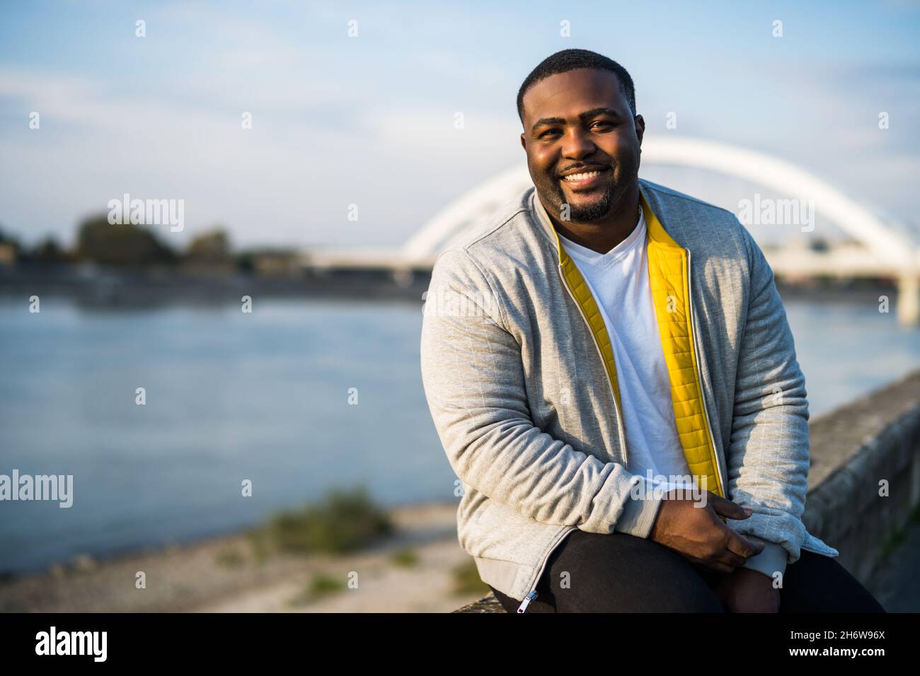 Happy black man enjoys resting by the river Stock Photo - Alamy