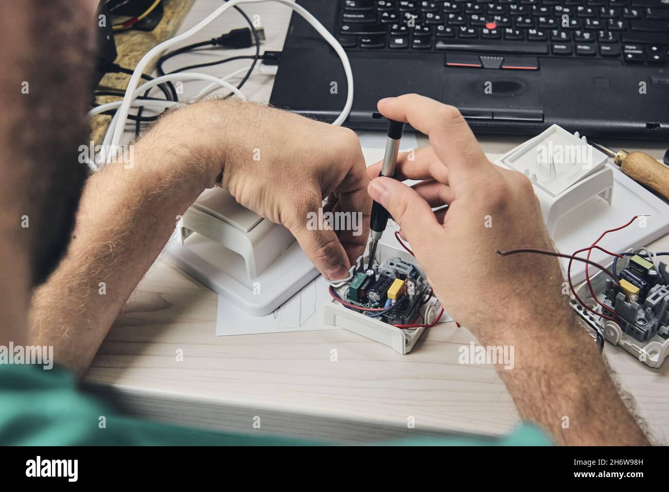 Repair of electronic devices, tin soldering parts. Hands of man holding ...
