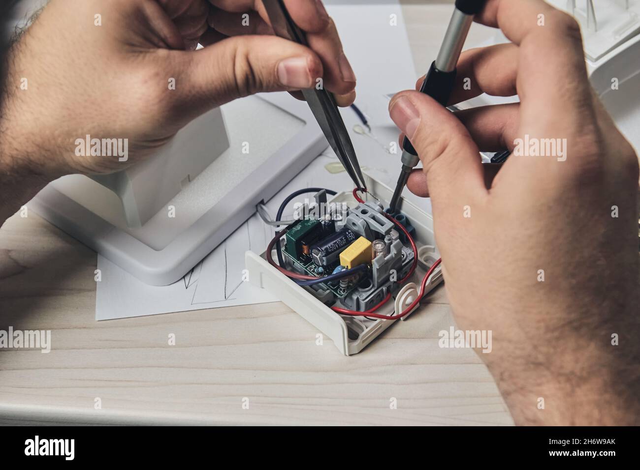 Repair of electronic devices, tin soldering parts. Hands of man holding ...