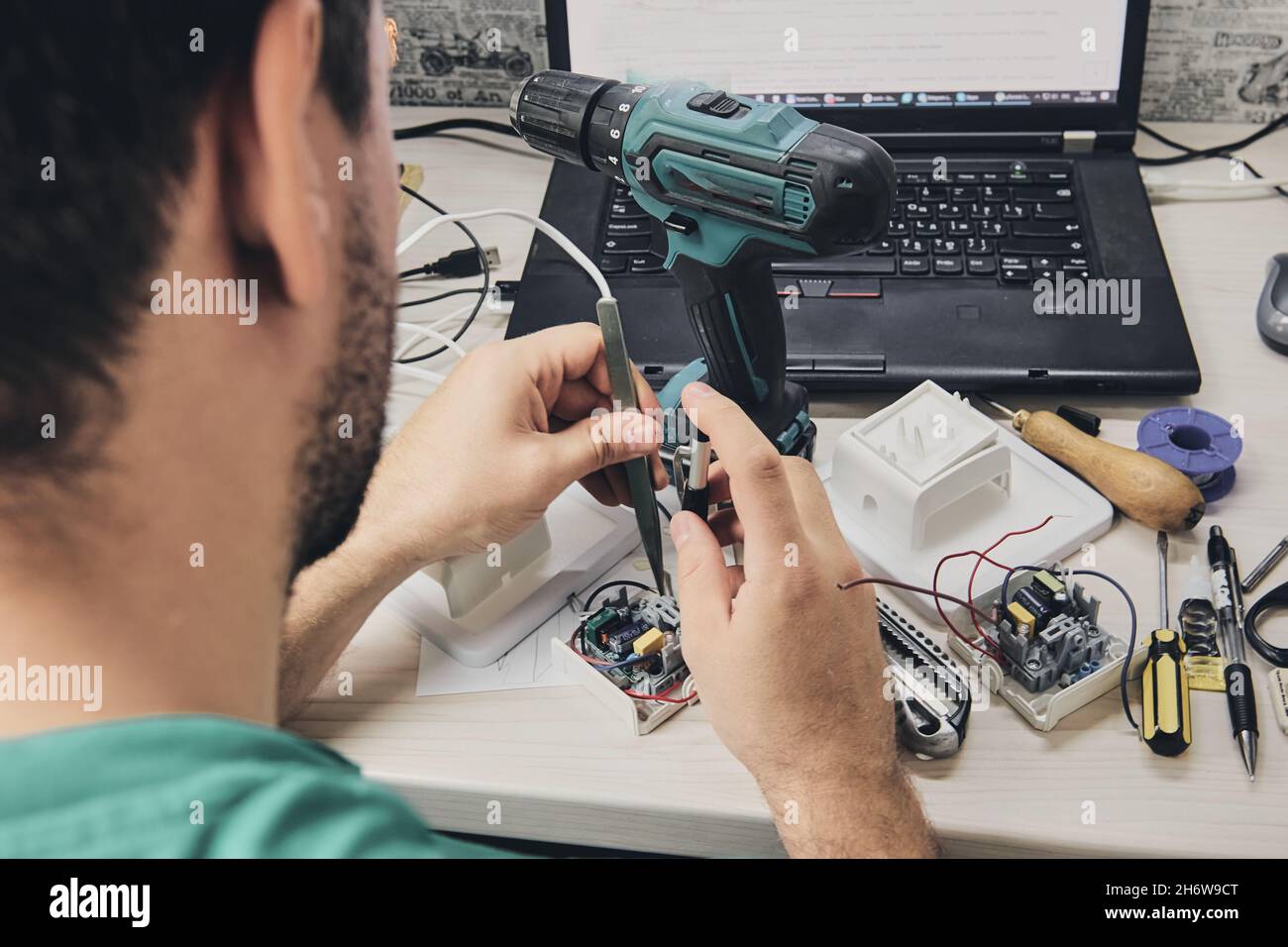 Repair of electronic devices, tin soldering parts. Hands of man holding ...