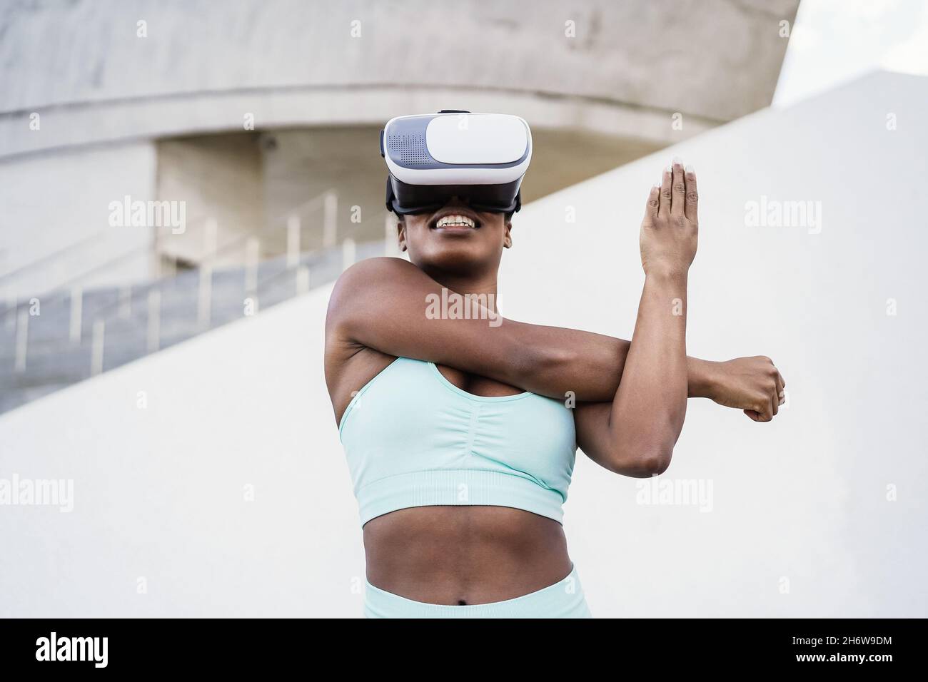 Fir african woman wearing virtual reality headset during sport workout ...