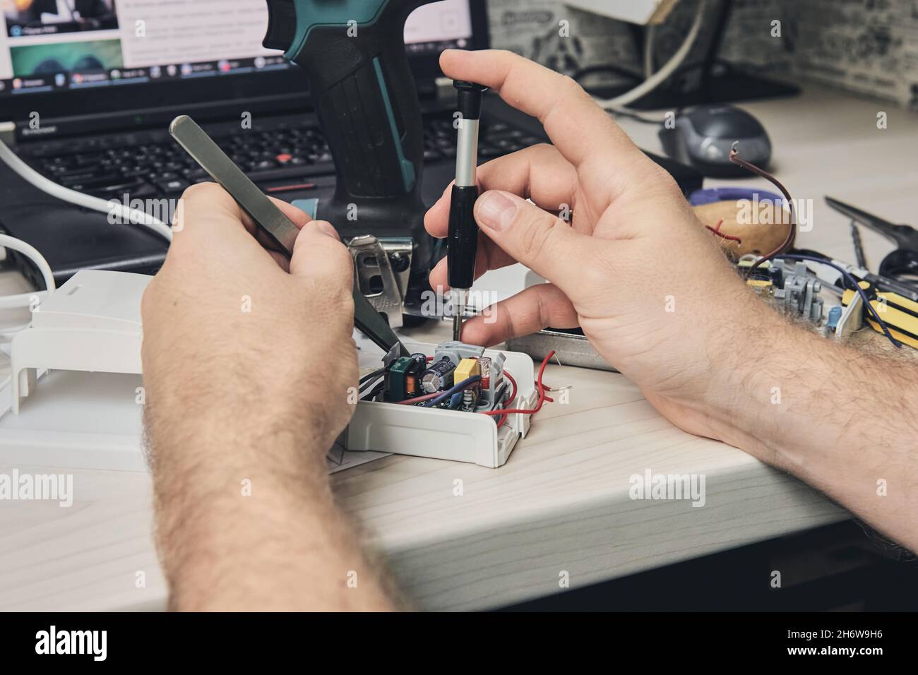 Repair of electronic devices, tin soldering parts. Hands of man holding ...