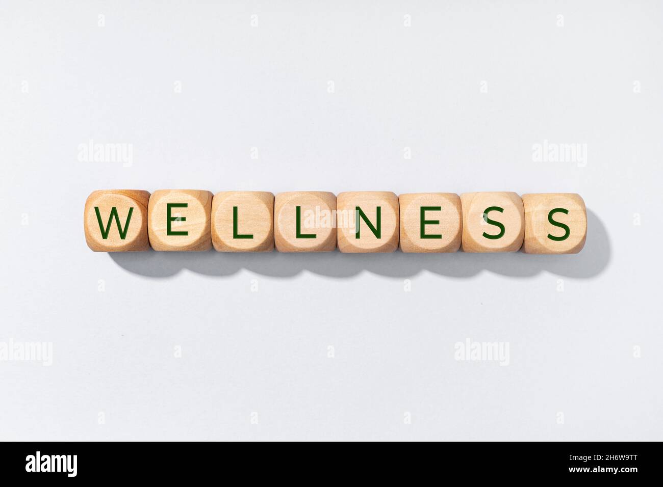 Wellness word in wooden blocks isolated on gray background Stock Photo ...