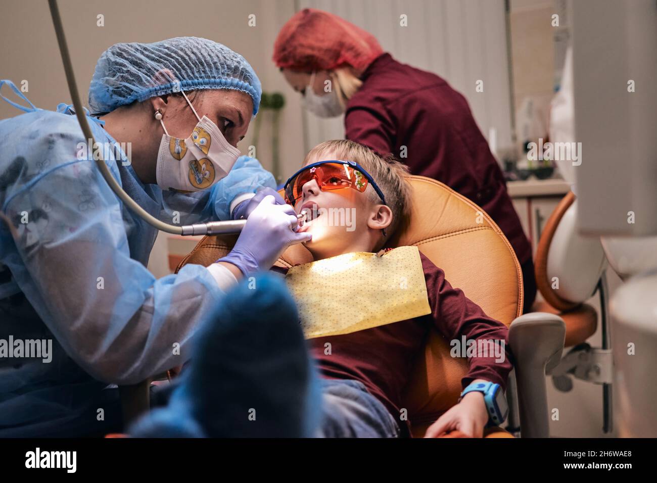 Boy sitting on dental chair with open mouth during oral checking up ... Boy sitting on dental chair with open mouth during oral checking up ...