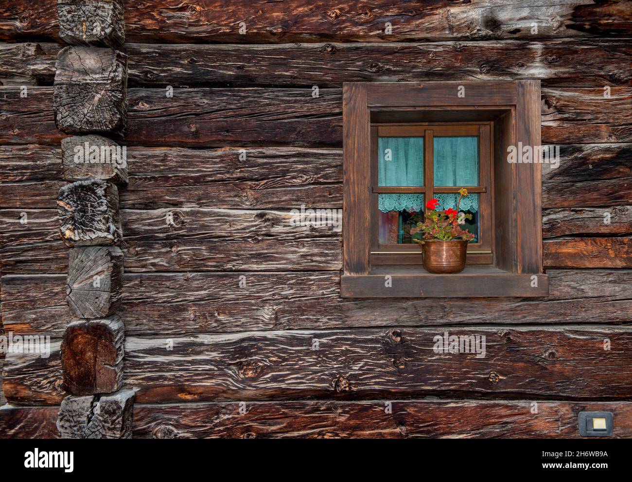 wooden house with flowers at the window Stock Photo - Alamy