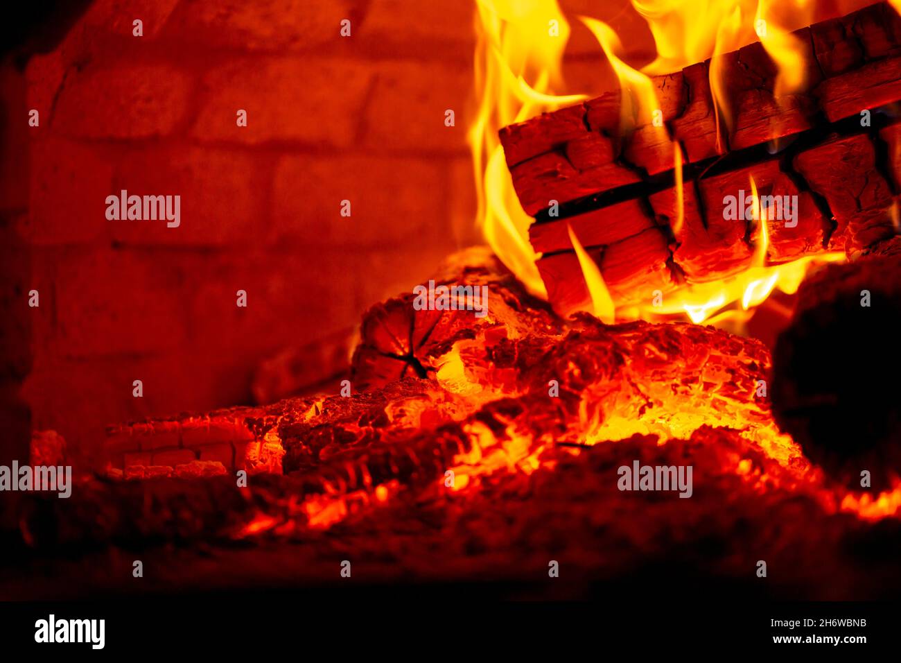 Burning log of wood in a fireplace close-up in a Barbecue Stock Photo ...