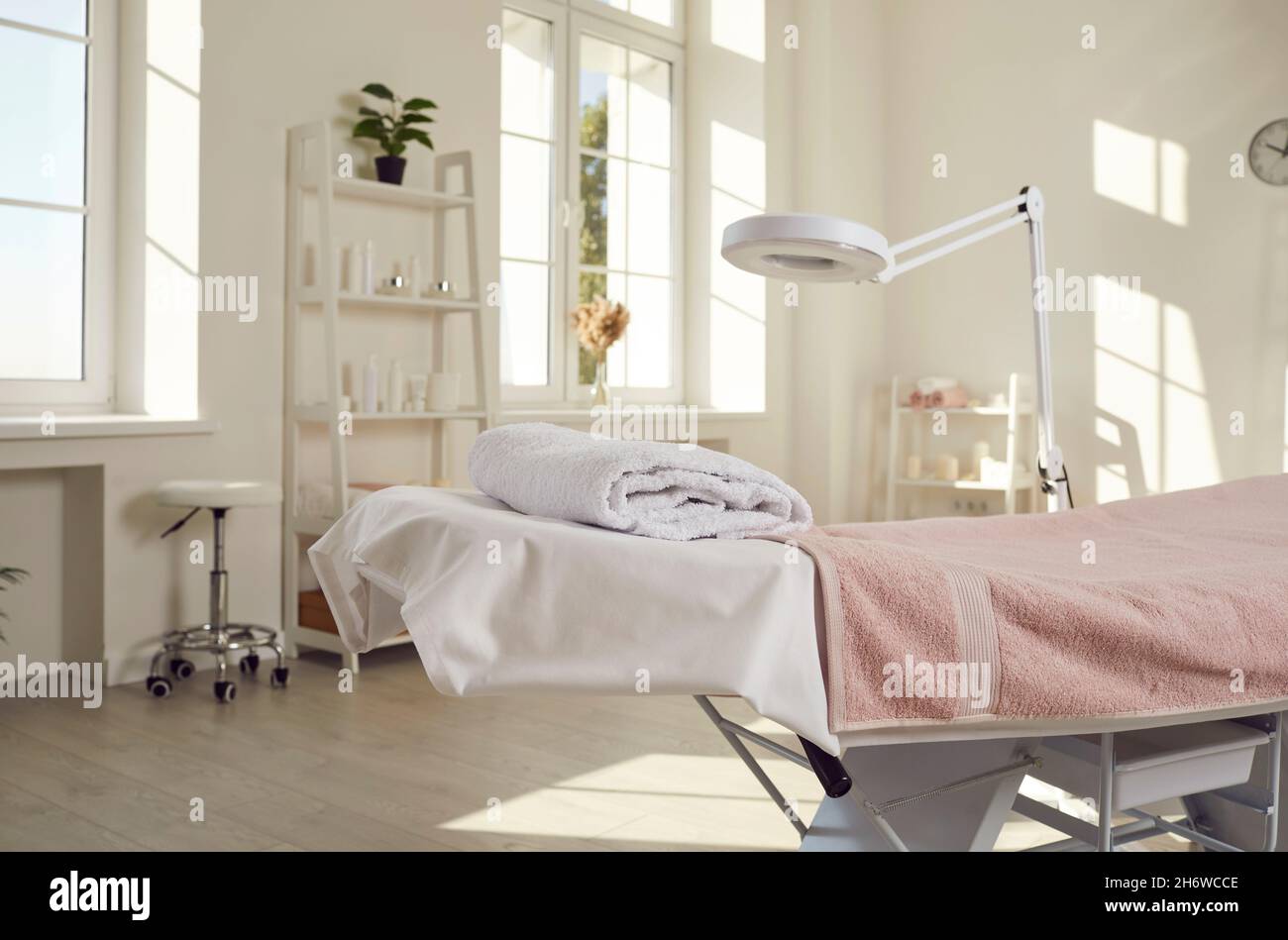 Empty interior of spa room or beauty salon with massage table and ...