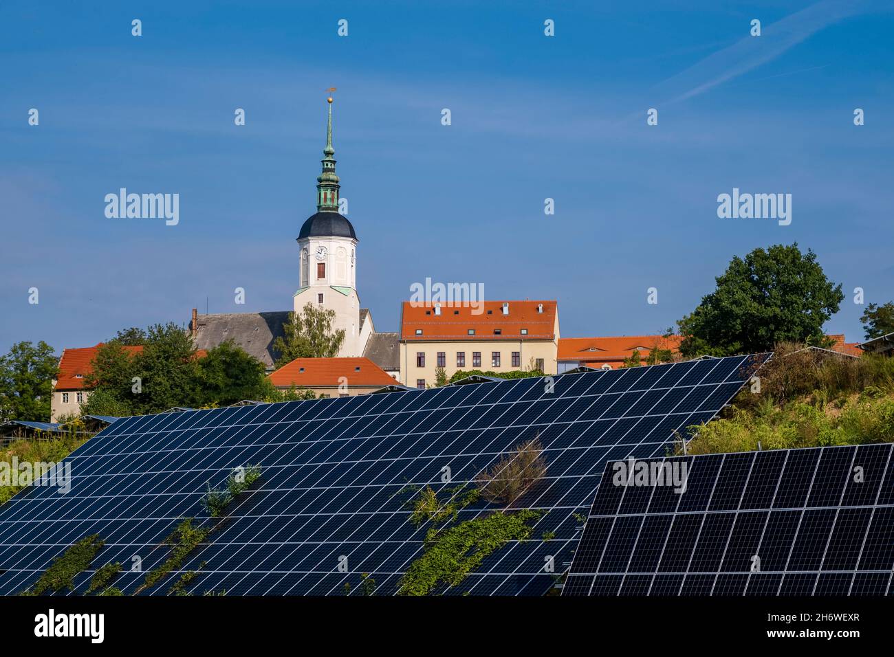 Photovoltaik solar panels arranged on the slope of a hill in front of ...