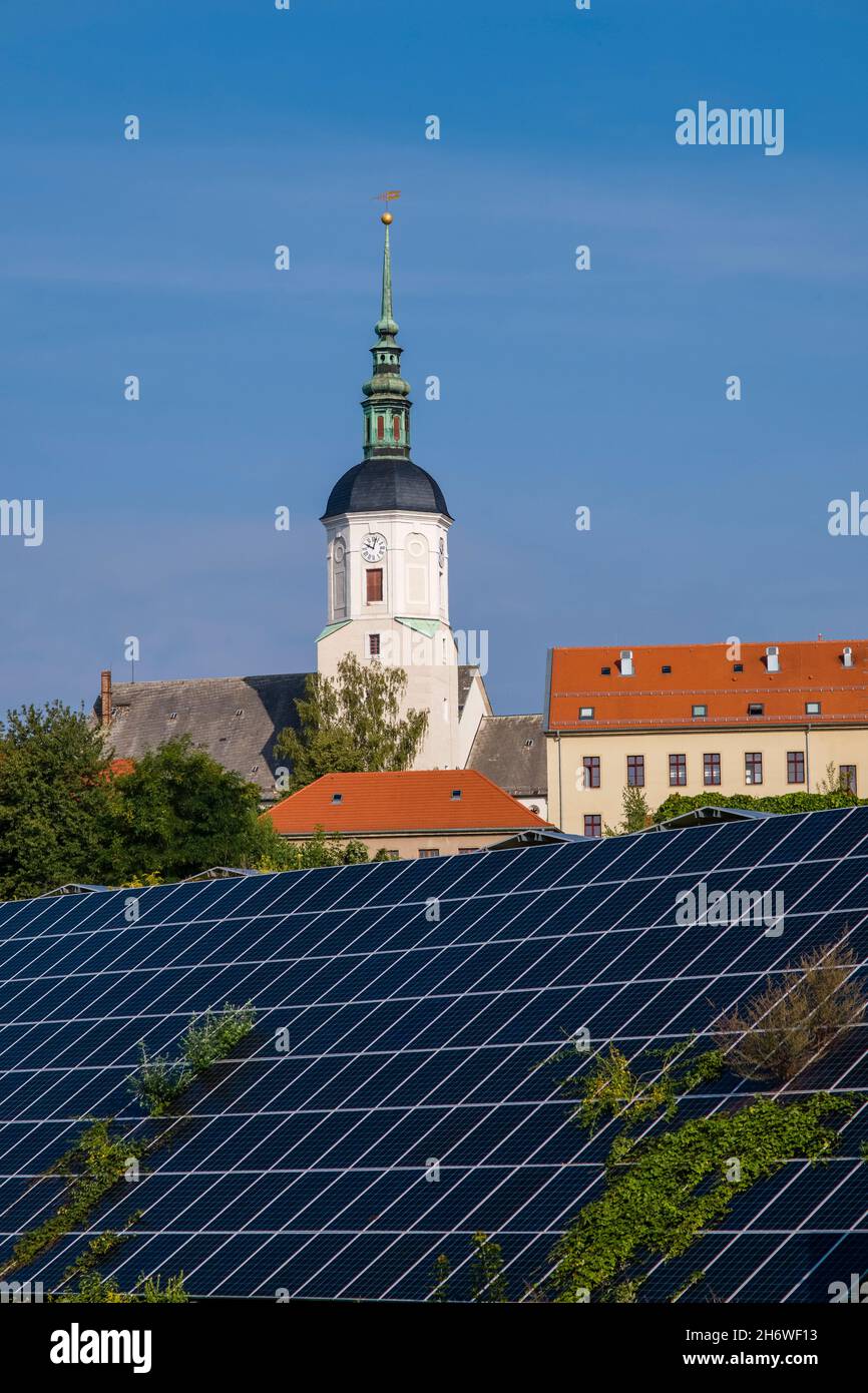 Photovoltaik solar panels arranged on the slope of a hill in front of ...