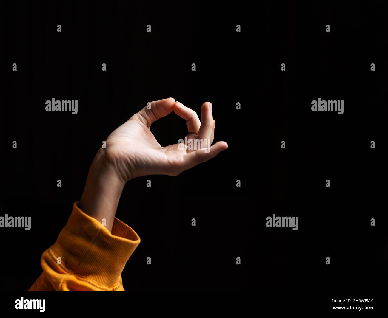 Woman holding om mudra on black background. Relaxation, concentration ...
