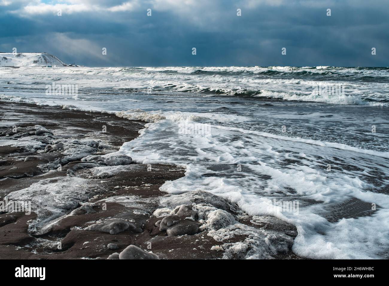 Winter landscape with frozen sea and icy beach. Storm and snow weather ...