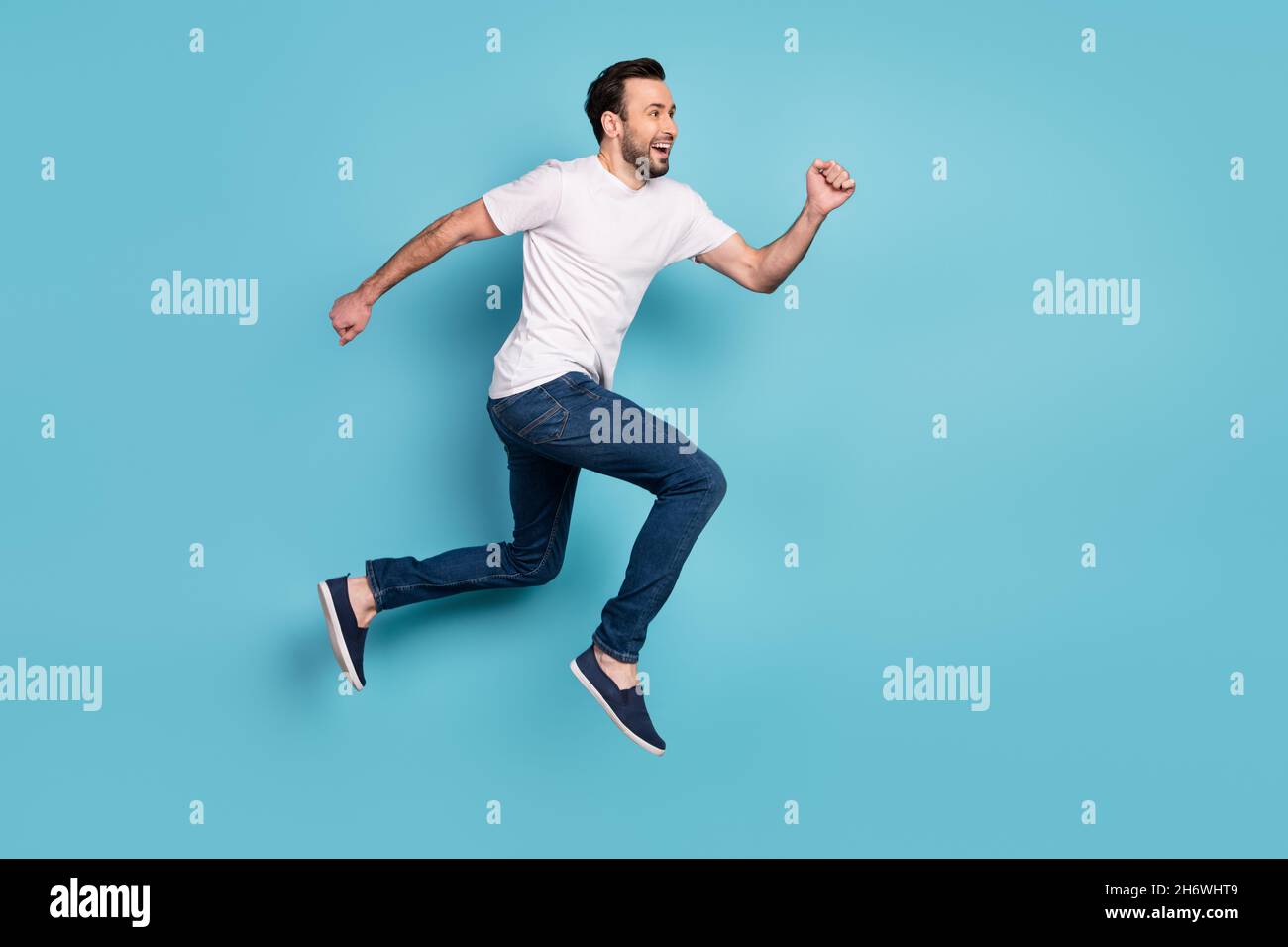Full body profile portrait of excited cheerful man look empty space ...