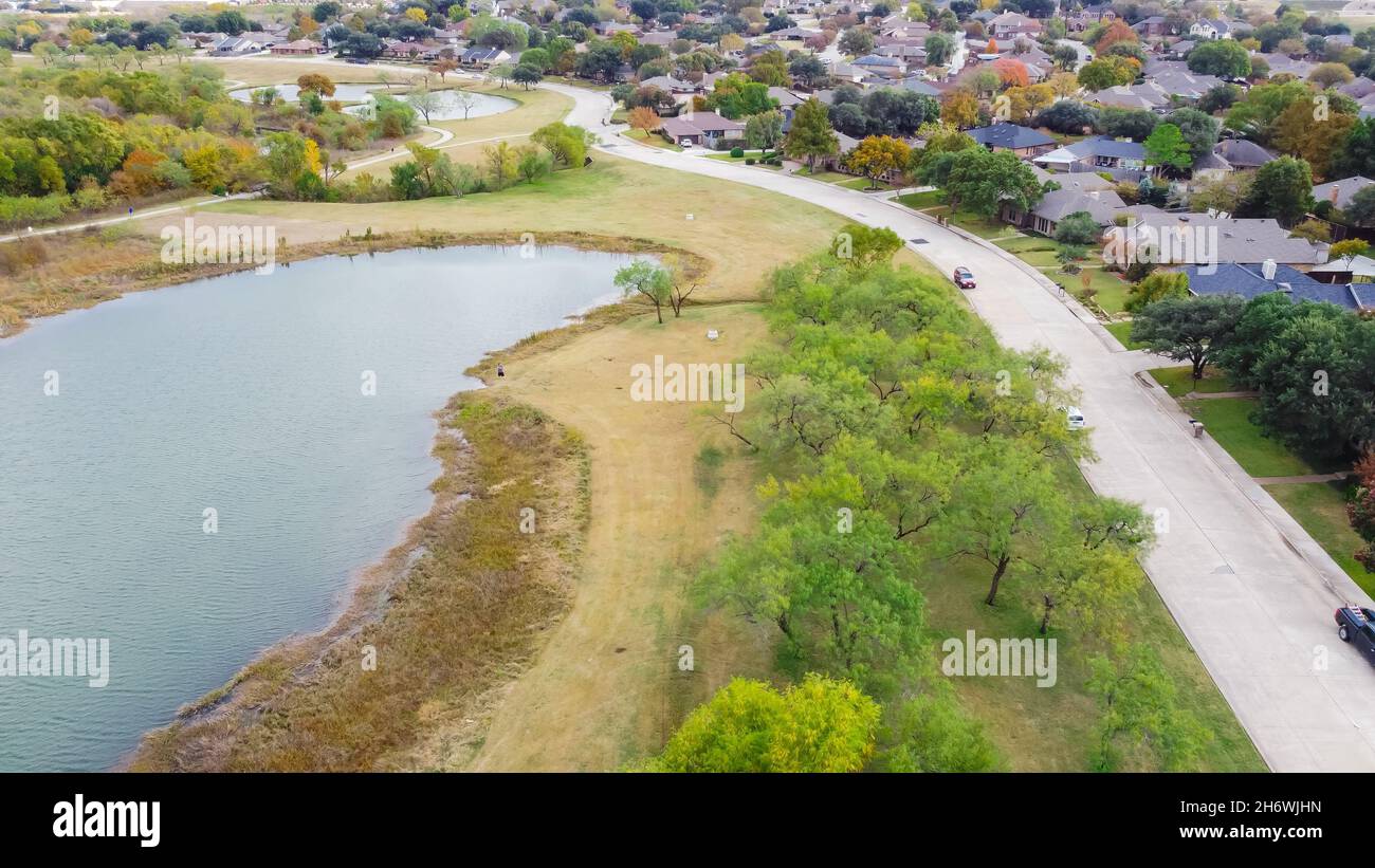Top view lakeside residential neighborhood with parked cars on street ...